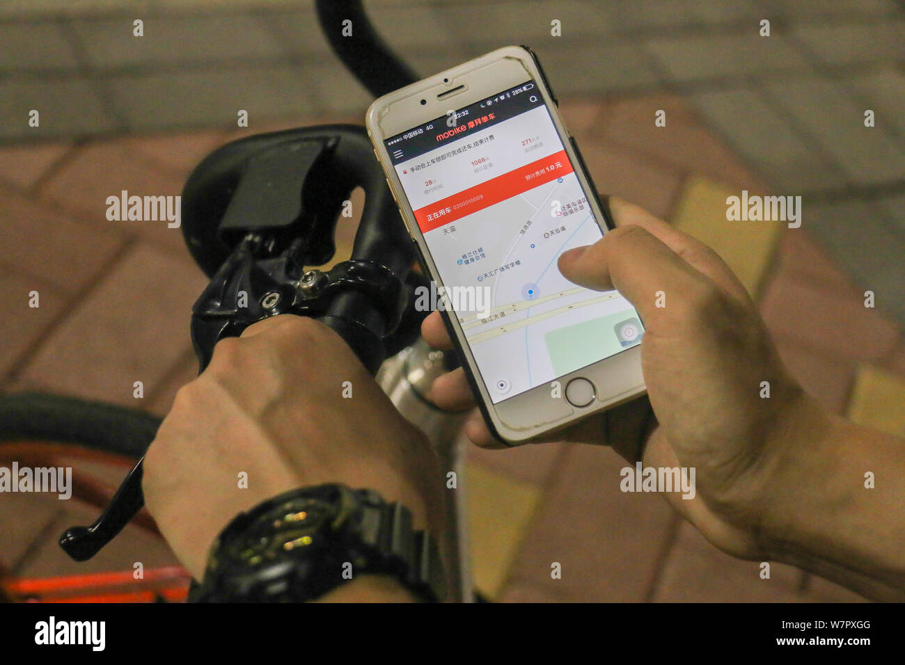 --FILE--A Chinese mobile phone user rides a bicycle of Chinese bike ...