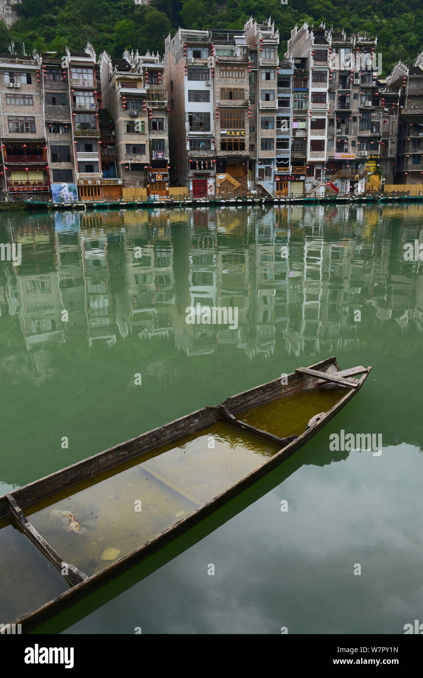 A boat is anchored on the Wuyang River in Zhenyuan ancient water town ...