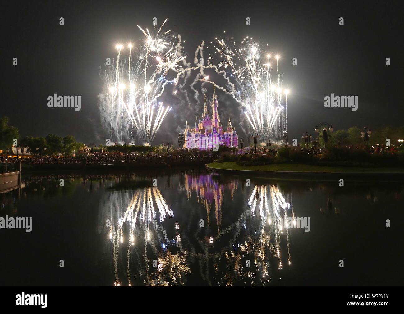 Fireworks explode over the Disney Castle during the first anniversary ...