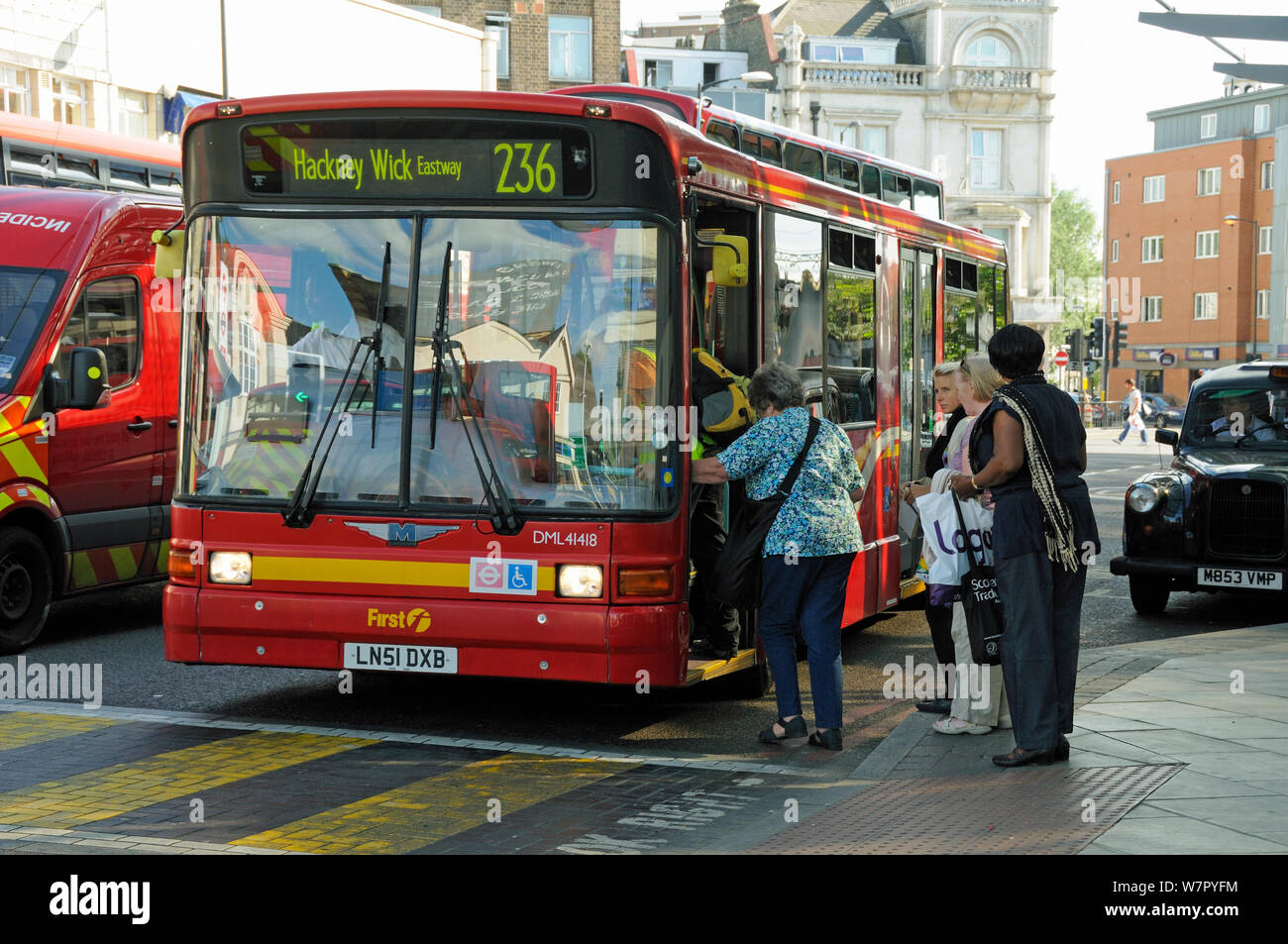 People boarding a single decker bus at Finsbury Park Bus Station ...