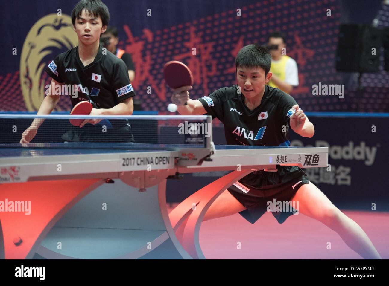 Harimoto Tomokazu of Japan, right, returns a shot as he and Kizukuri ...