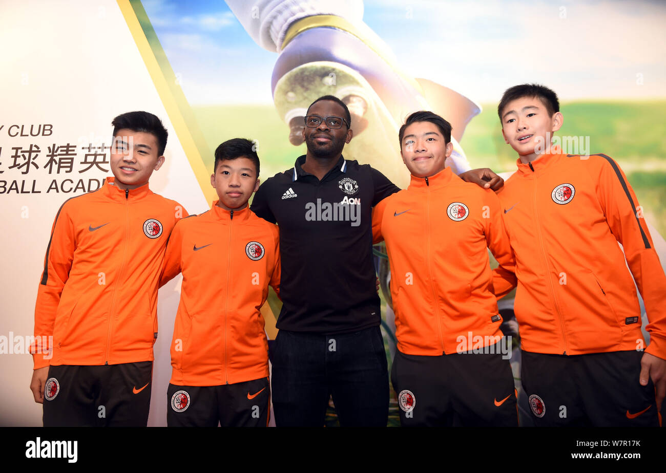 Former French soccer player Louis Saha, center, poses during a press ...