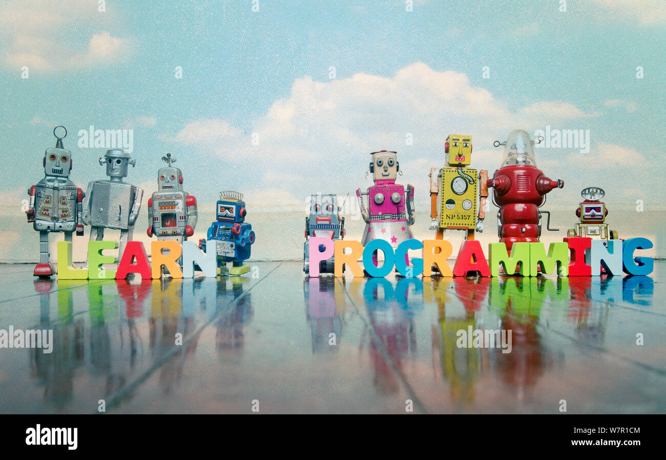 LEARN PROGRAMMING wooden letters and retro robot toys on a wooden floor ...