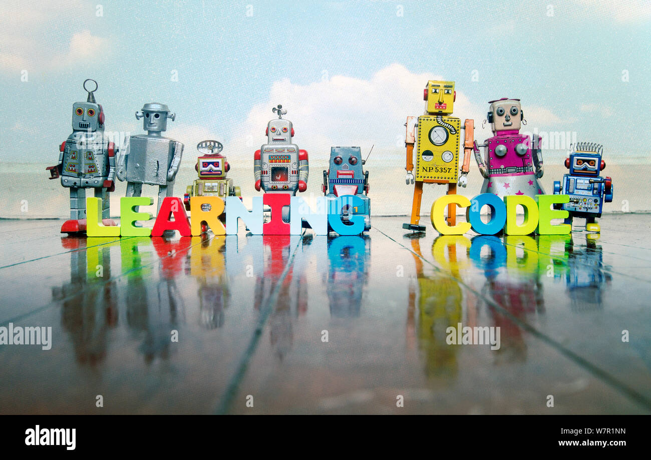 LEARNING CODE wooden letters and retro robot toys on a wooden floor ...