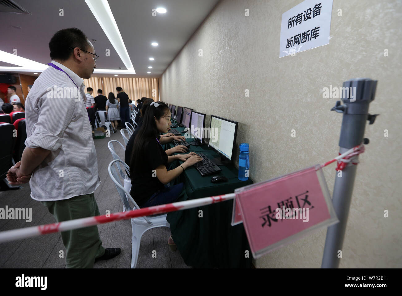Chinese workers input test questions into the artificial intelligence ...