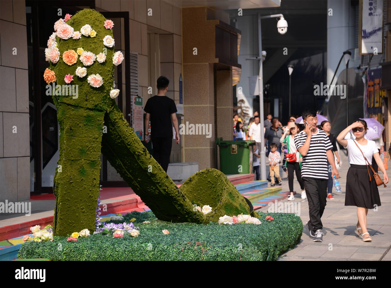 Pedestrians walk past a 3.2-meter-long and 0.5-meter-wide art ...