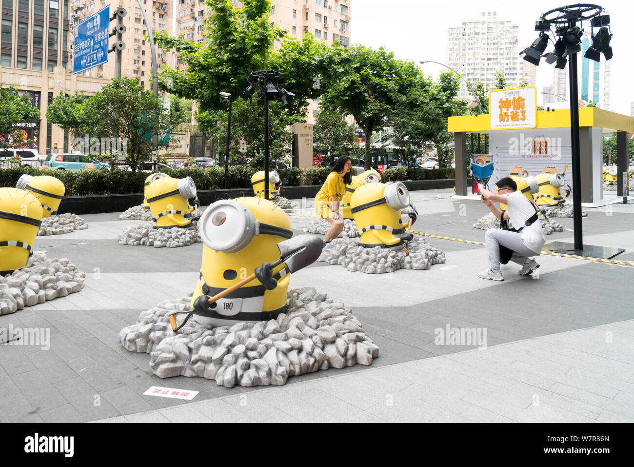 A Chinese citizen takes photos with Minions-shaped sculptures armed ...