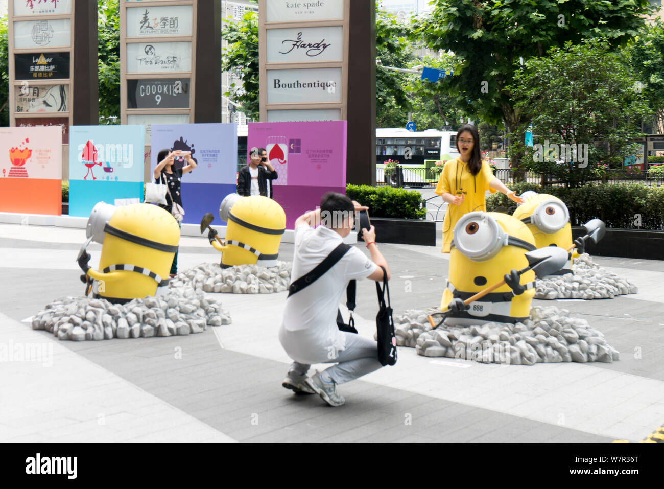 A Chinese citizen takes photos with Minions-shaped sculptures armed ...
