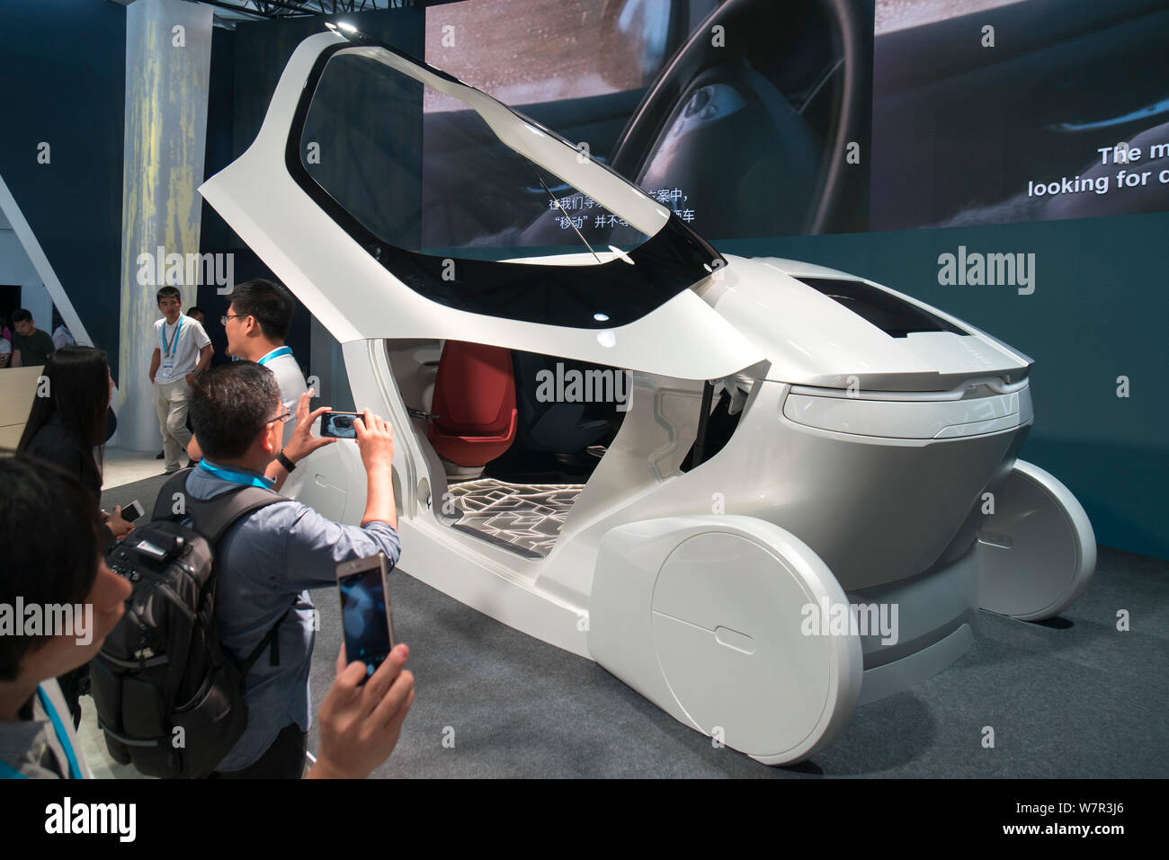 Visitors take photos of a self-driving concept car "InMotion" of ...