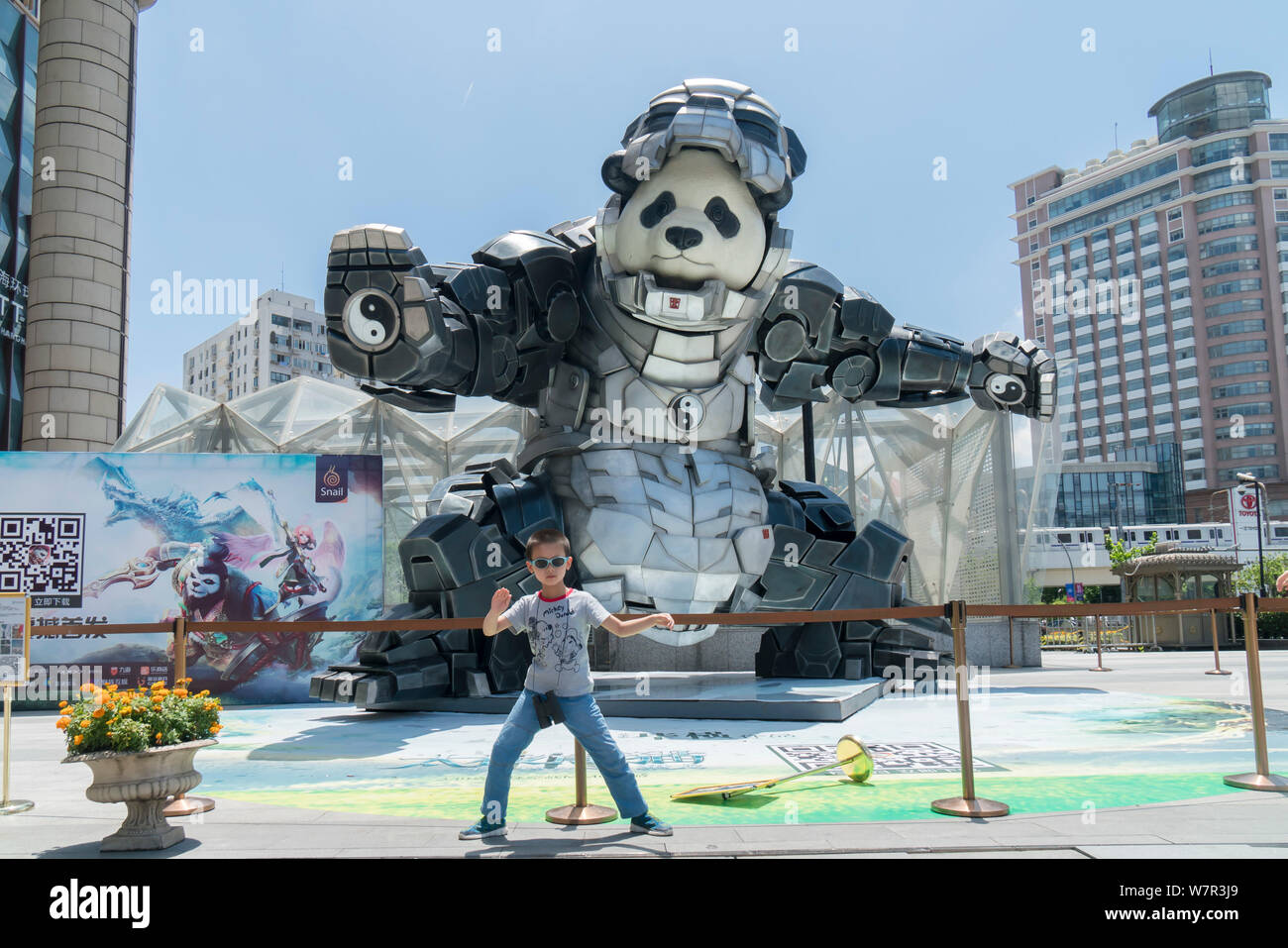 A young boy poses with a Tai Chi panda sculpture on display in front of ...