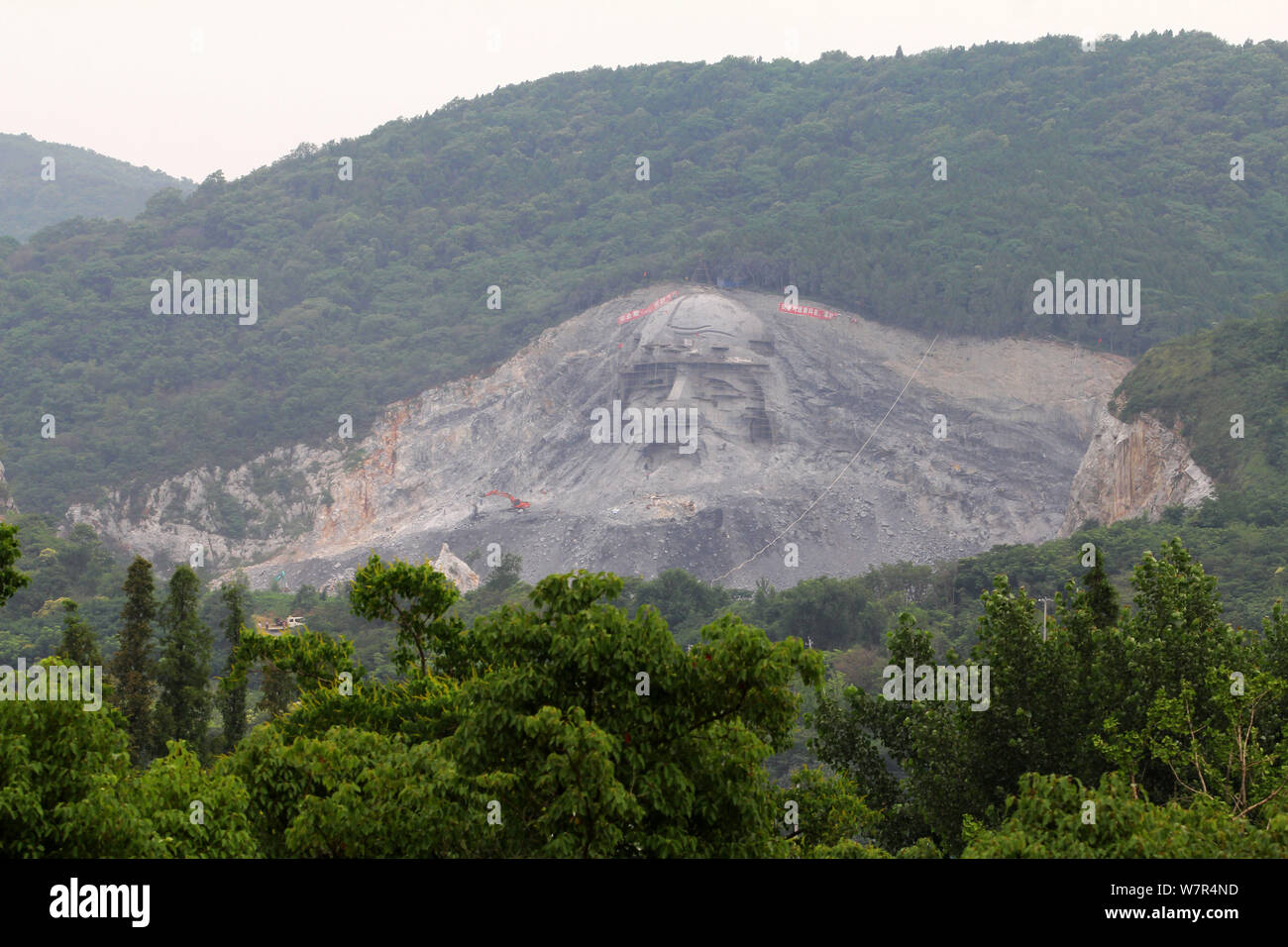 A sculpture of Fuxi, a culture hero in Chinese legends, is being carved ...