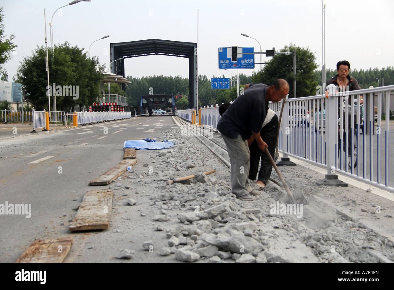 Chinese workers demolish the special tracks for the test drive of the ...