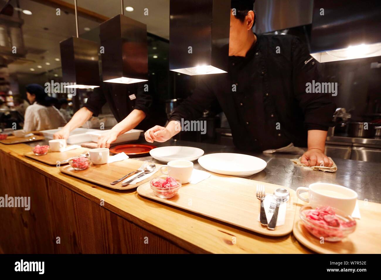 Chefs make dishes at the world's first MUJI Diner on Huaihai Road in ...