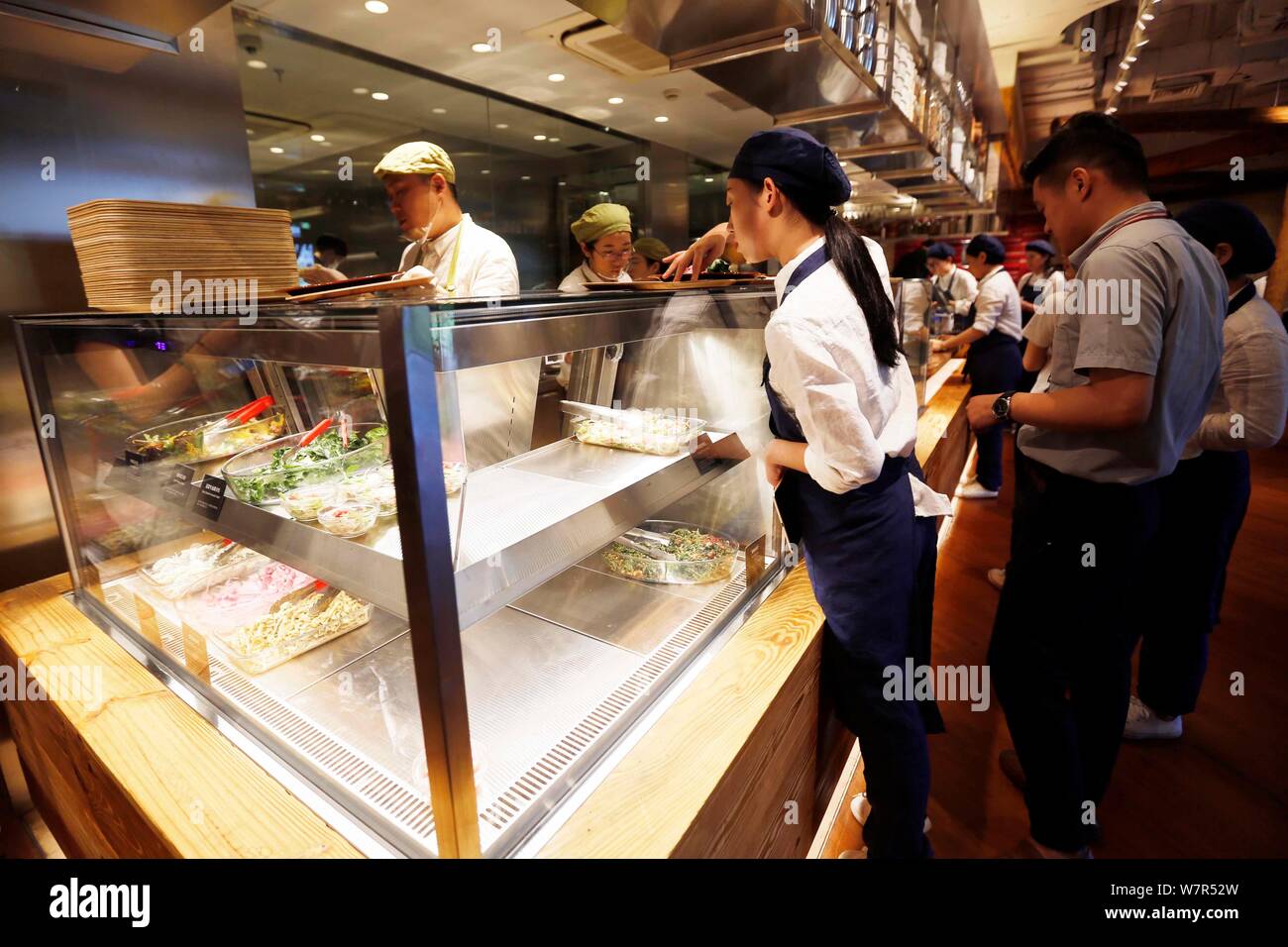 Customers and attendants are seen at the world's first MUJI Diner on ...