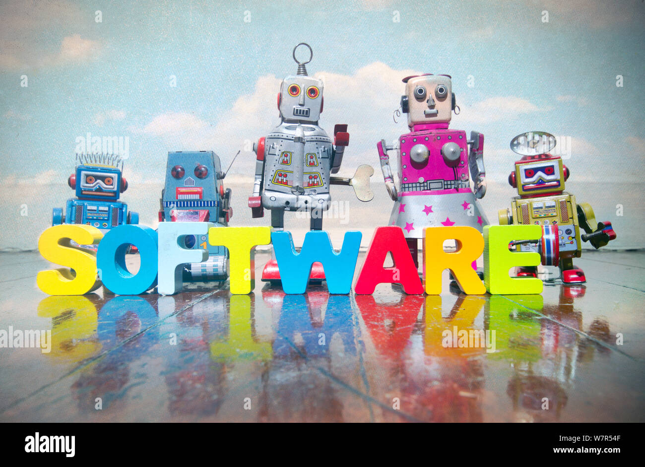 the word SOFTWARE made wit wooden letters and robot toys on a wooden ...