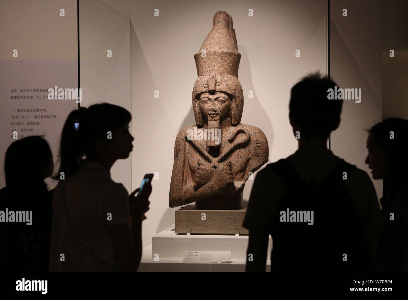 Visitors look at the Statue of Ramesses II from Egypt displayed during ...