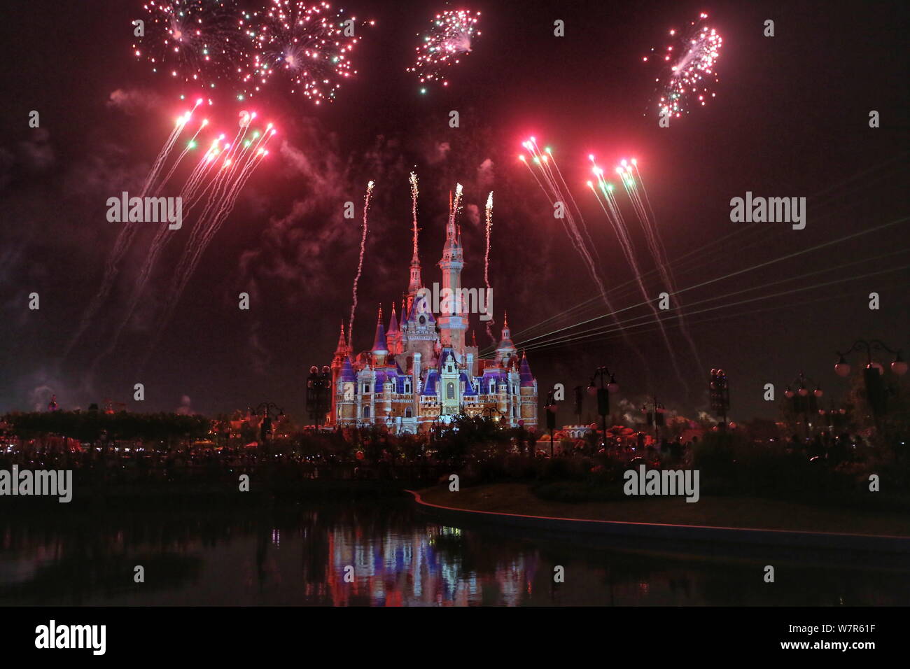 Fireworks explode over the Disney Castle during the first anniversary ...