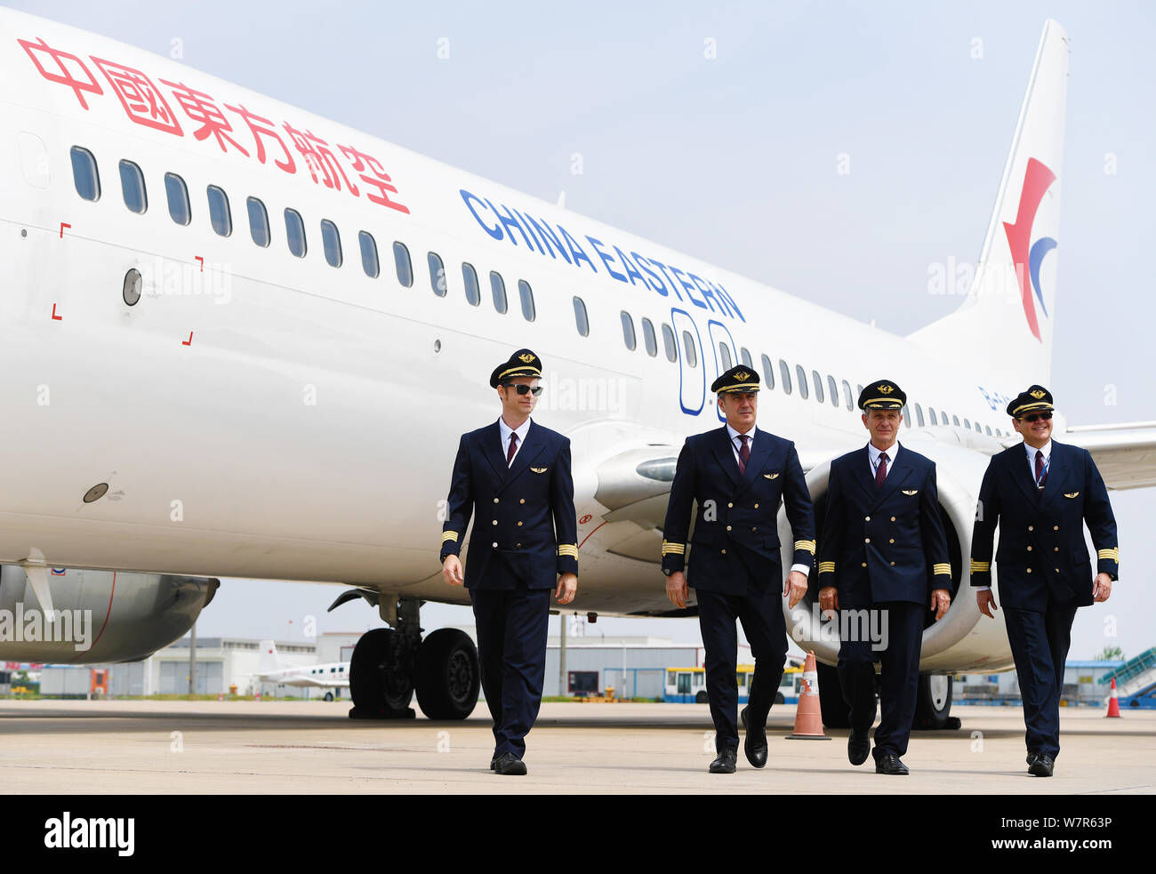 --FILE--Foreign pilots walk in front of a jet plane of China Eastern ...