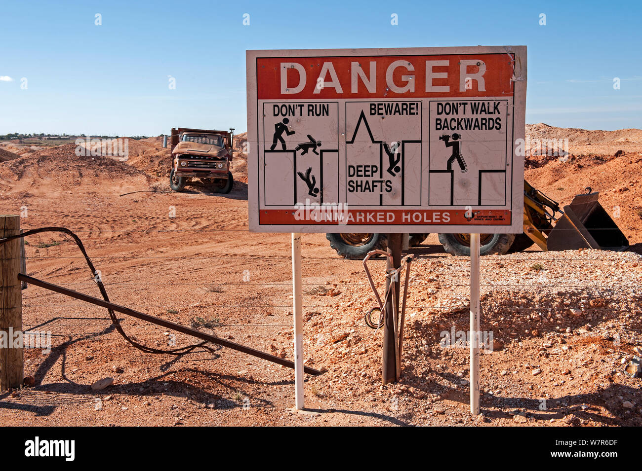Sign warning visitors about the danger of mine shafts, Coober Pedy - a ...