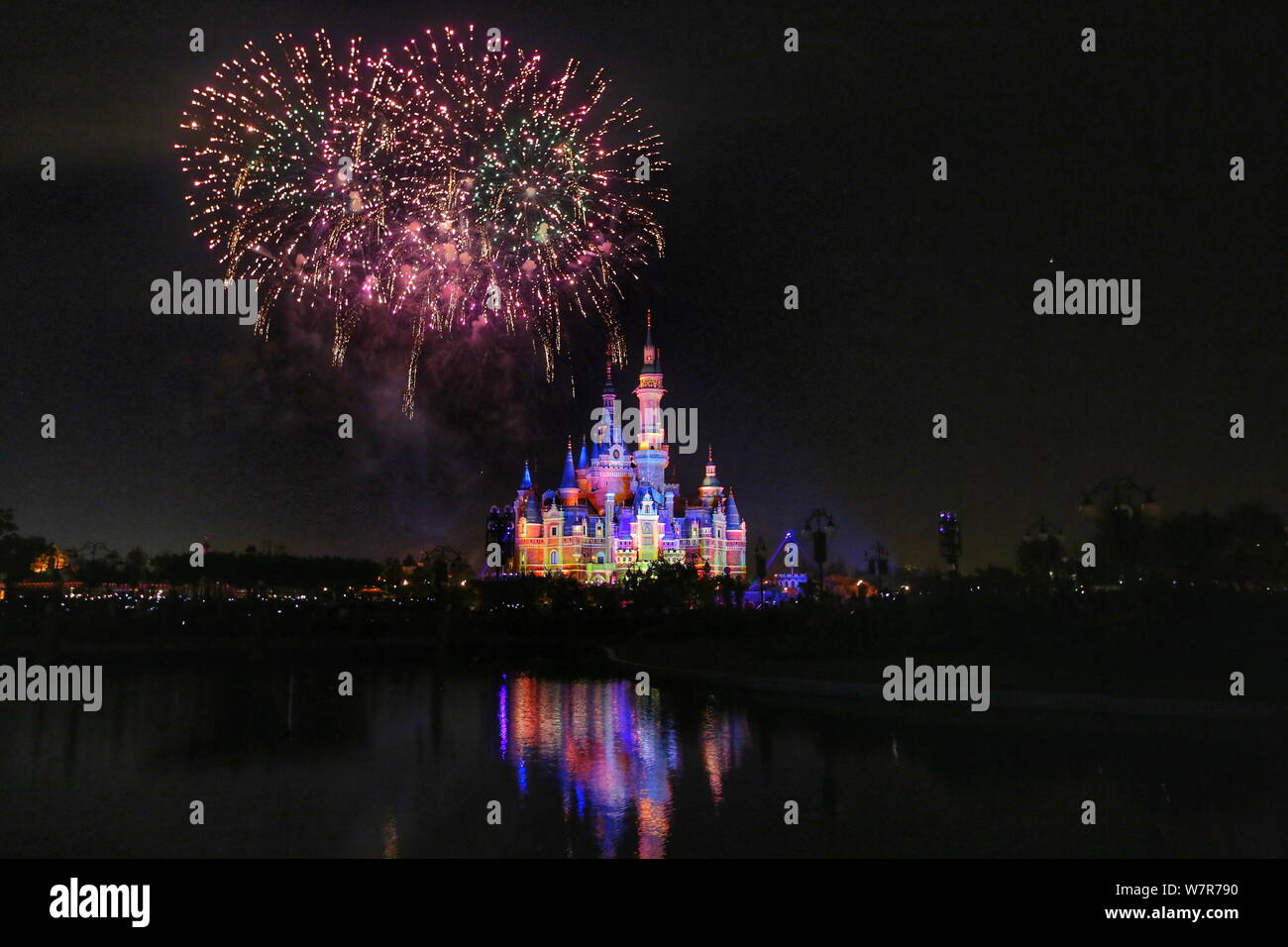 Fireworks explode over the Disney Castle during the first anniversary ...