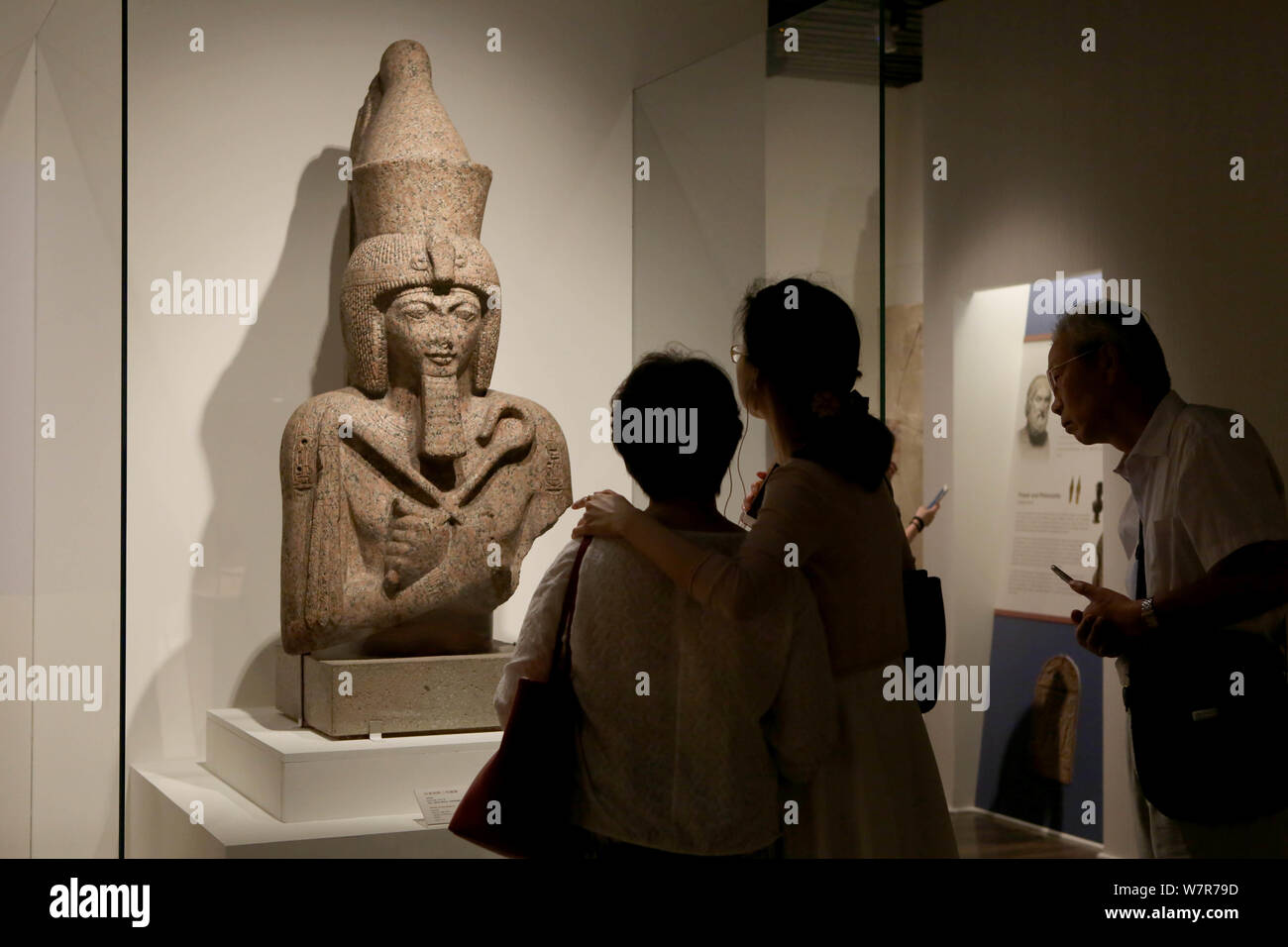 Visitors look at the Statue of Ramesses II from Egypt displayed during ...