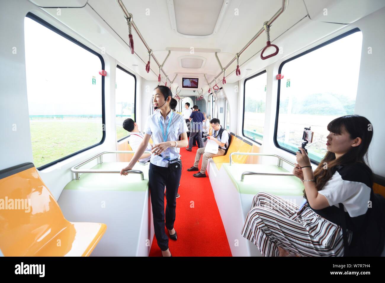 Visitors take the world's first railless train, developed by the CRRC ...