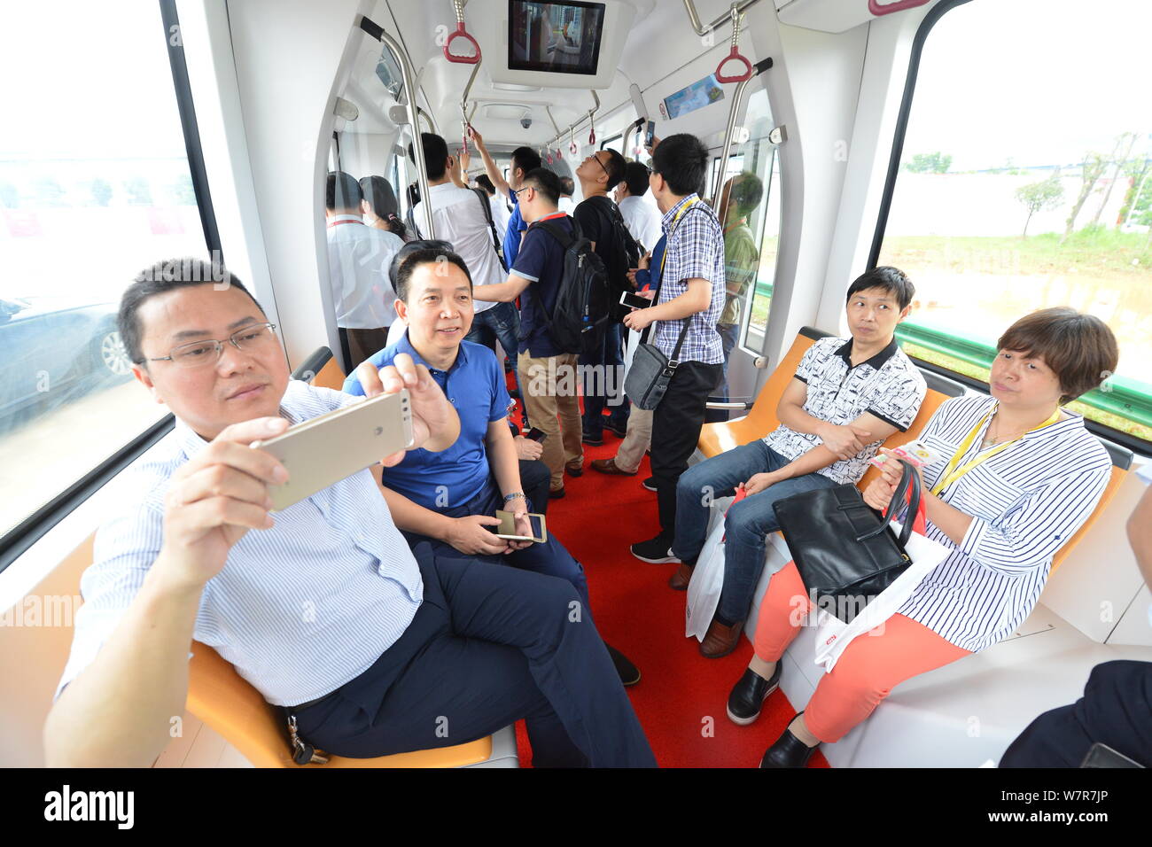 Visitors take the world's first railless train, developed by the CRRC ...