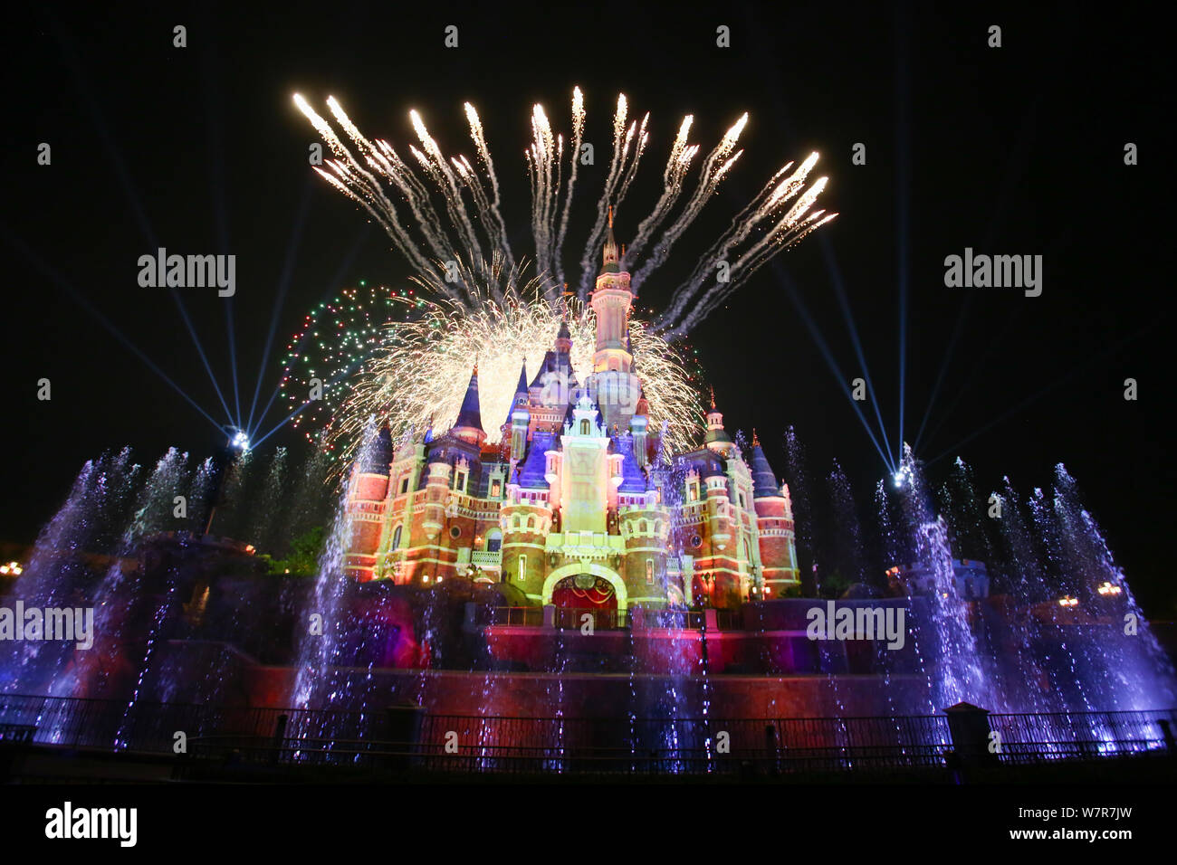 Fireworks explode over the Disney Castle during the first anniversary ...