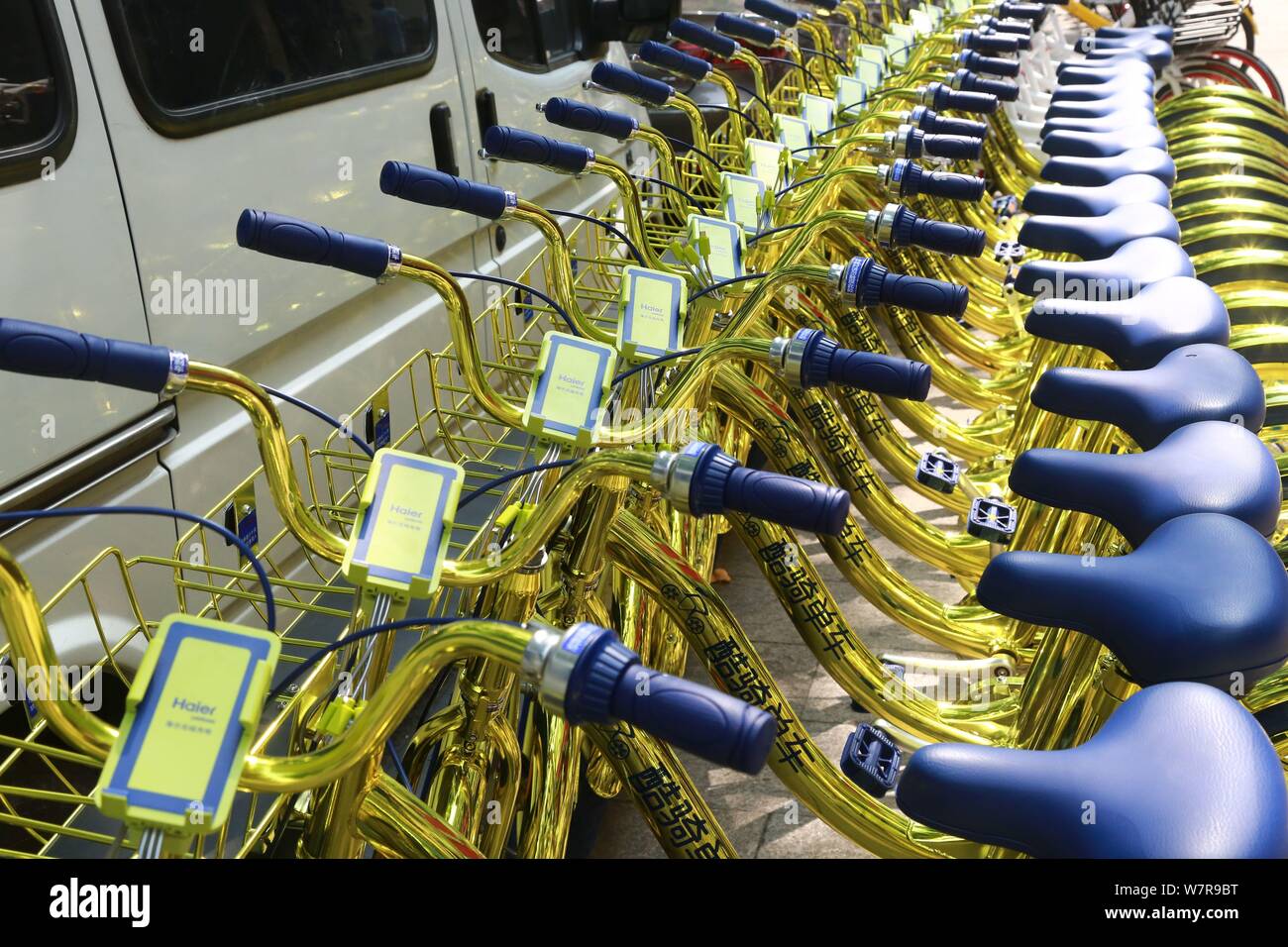 Golden bicycles of a Chinese bike-sharing service are lined up on a road in Hangzhou city, east ...