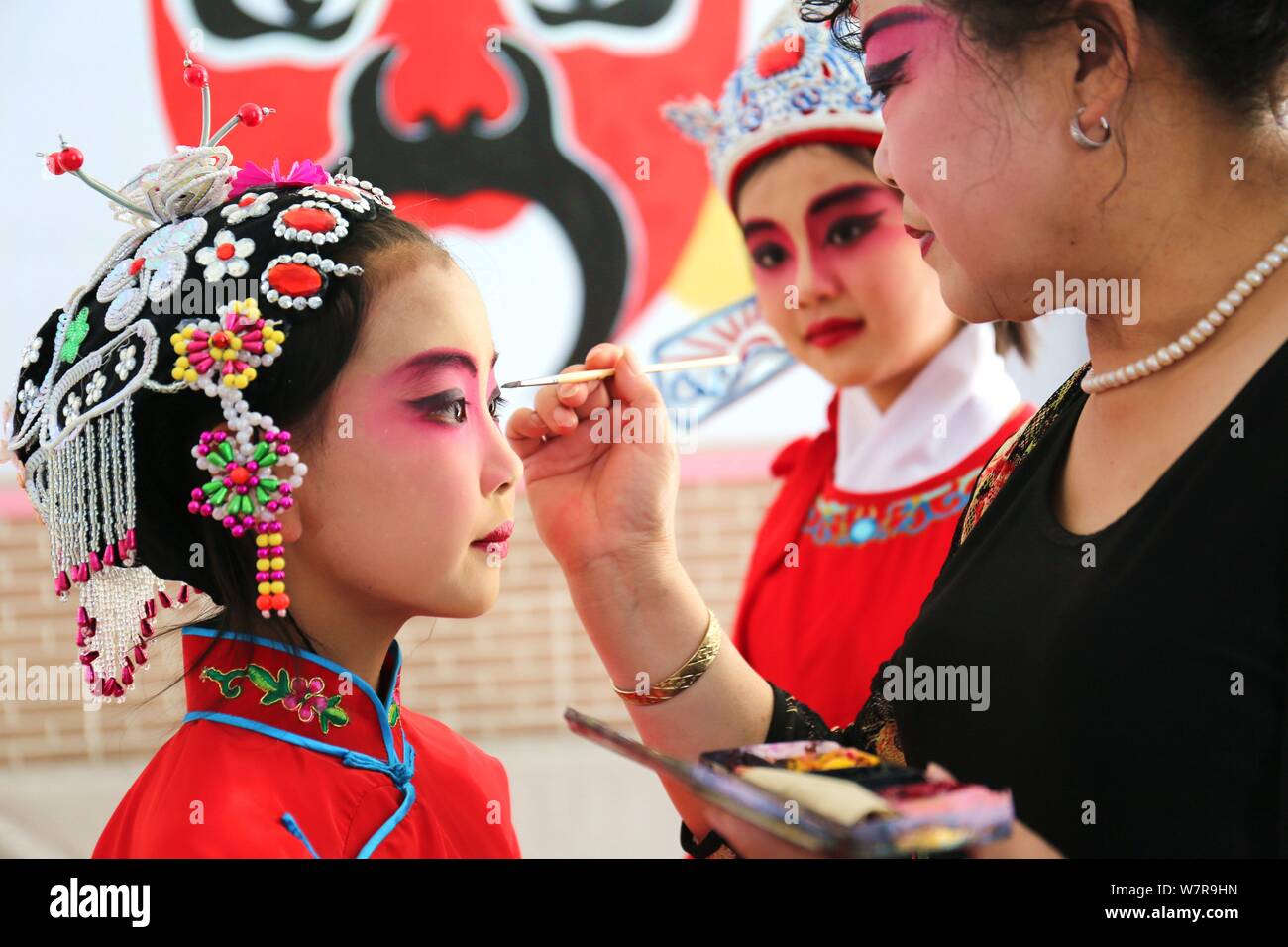 A pupil from Binhe primary school finishes her elaborate Pingju or Ping ...