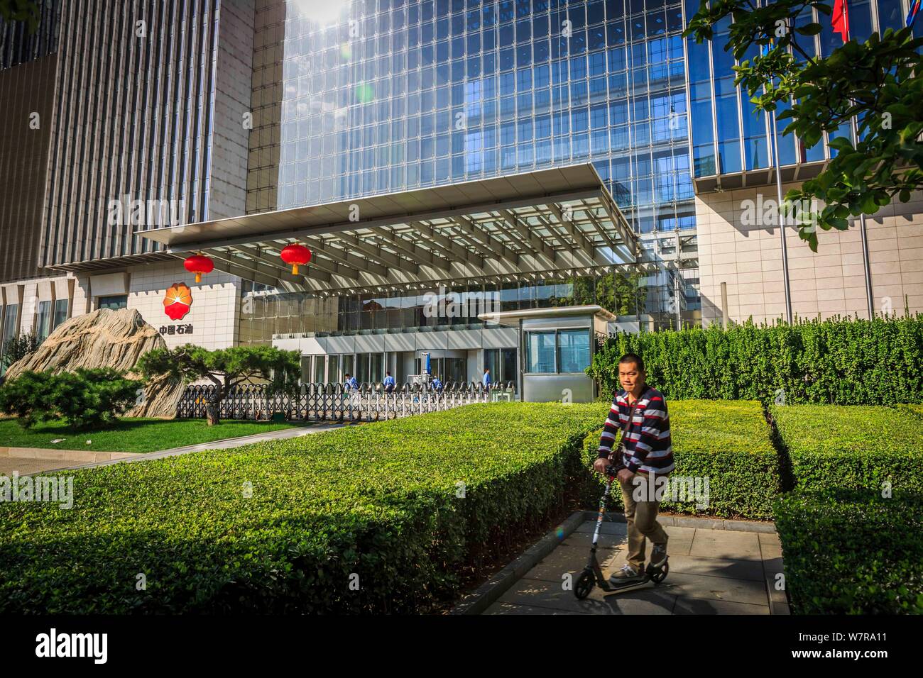 --FILE--A man passes by the headquarters building of CNPC (China ...