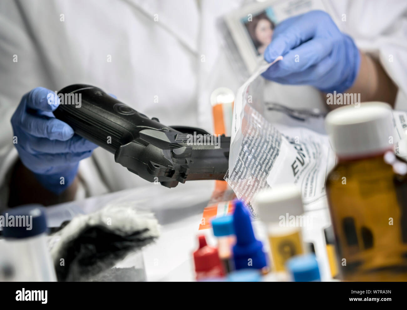 Scientific police officer examining traces of a gun in ballistic ...