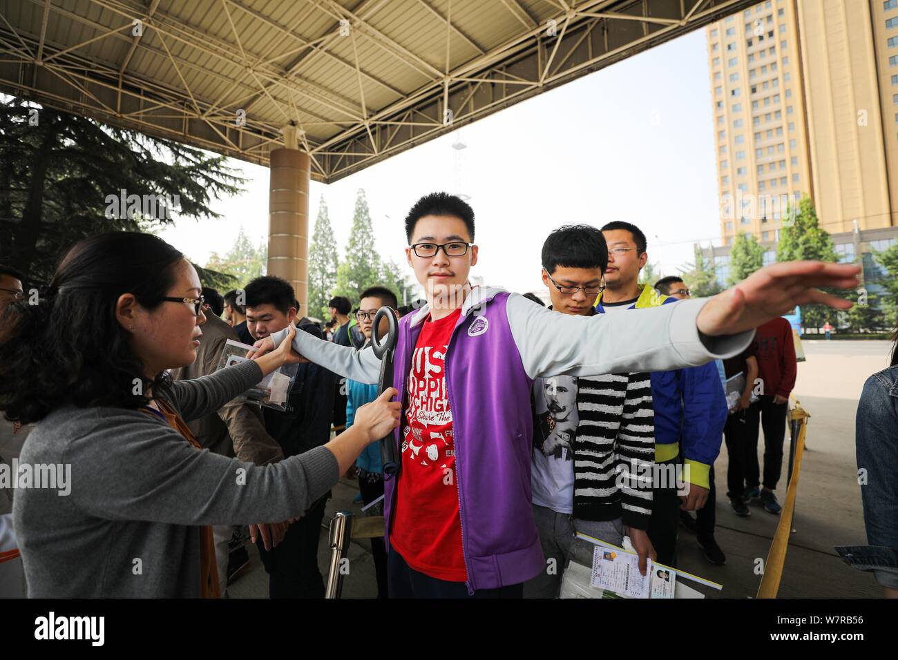 Chinese inspectors scan student examinees during an anti-cheating ...