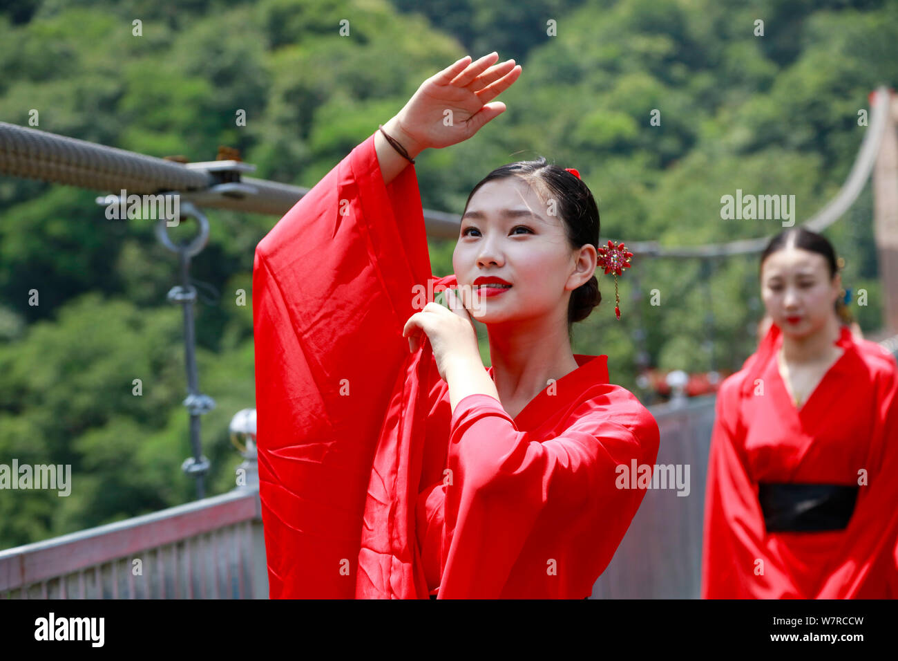Female graduates dressed in traditional Chinese costumes pose for ...