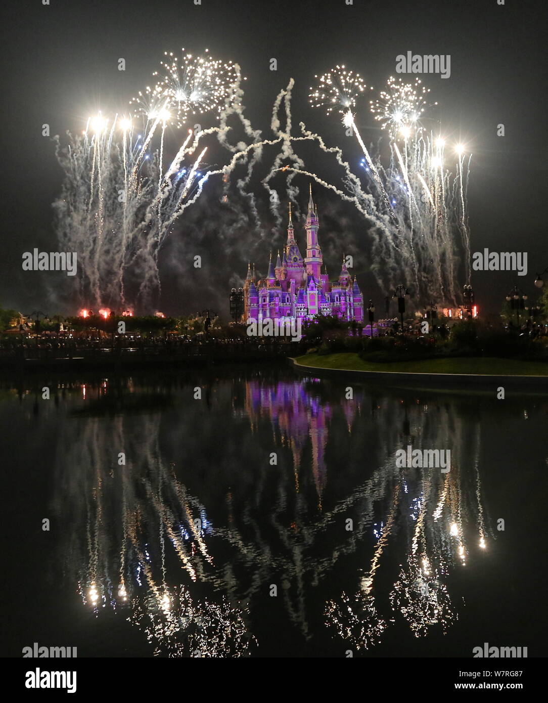 Fireworks explode over the Disney Castle during the first anniversary ...