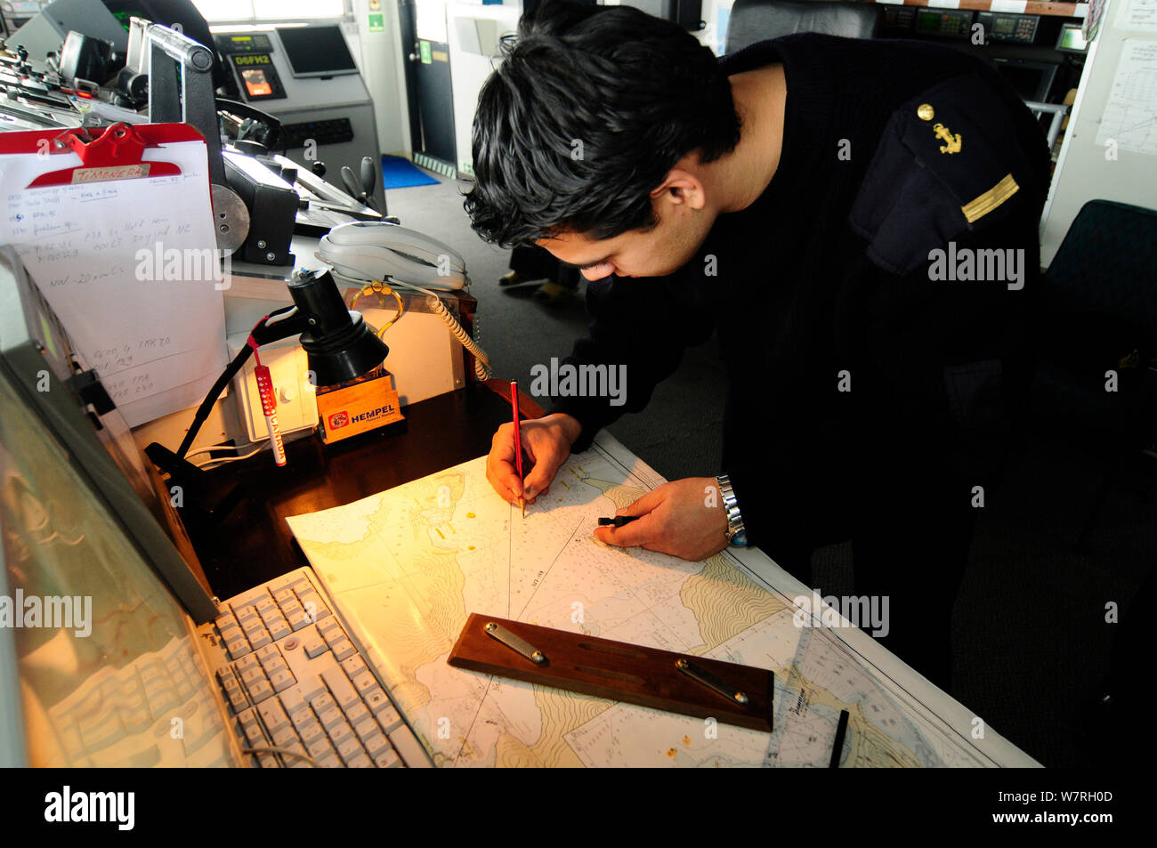 Navigator working on a map on the bridge on an Antarctic cruise liner ...