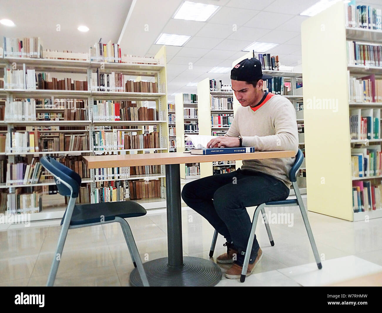 Young latino student doing homework Stock Photo - Alamy