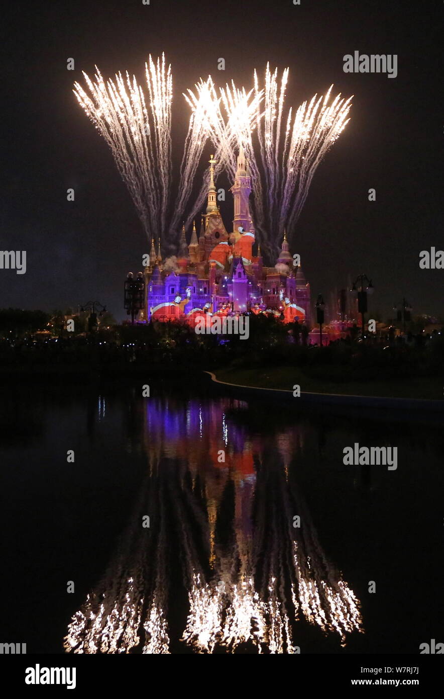Fireworks explode over the Disney Castle during the first anniversary ...