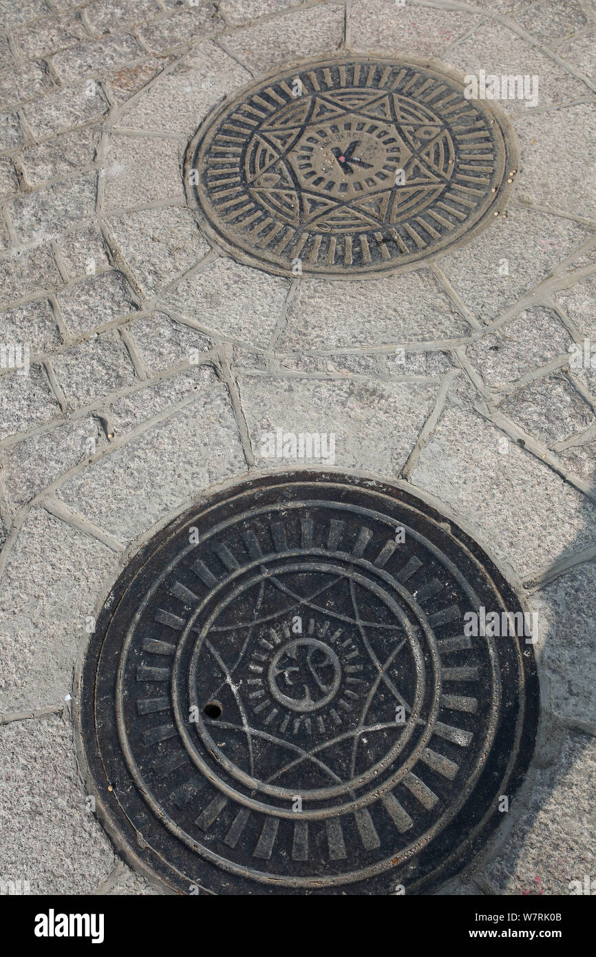 View of sewer manhole covers, derived from the German's gullies, on a ...