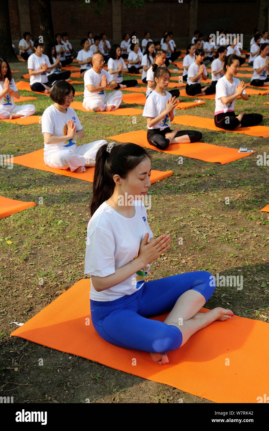 Chinese enthusiasts perform yoga to mark the mark the International ...