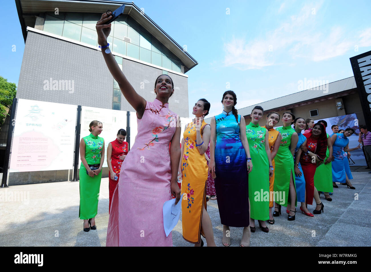 Women from different countries dressed in cheongsam, also known as ...