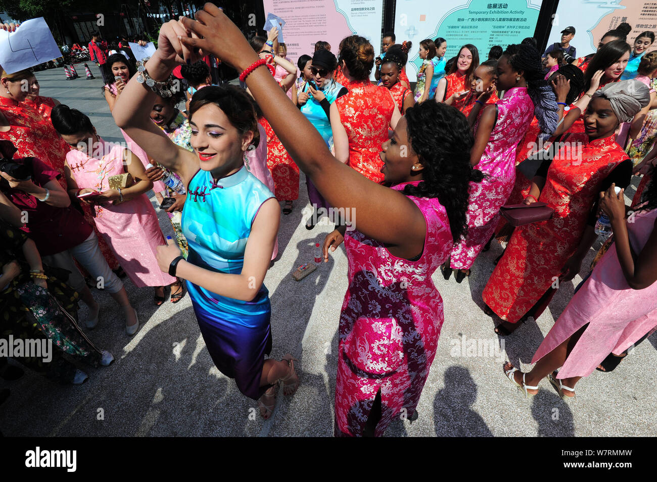 Women from different countries dressed in cheongsam, also known as ...