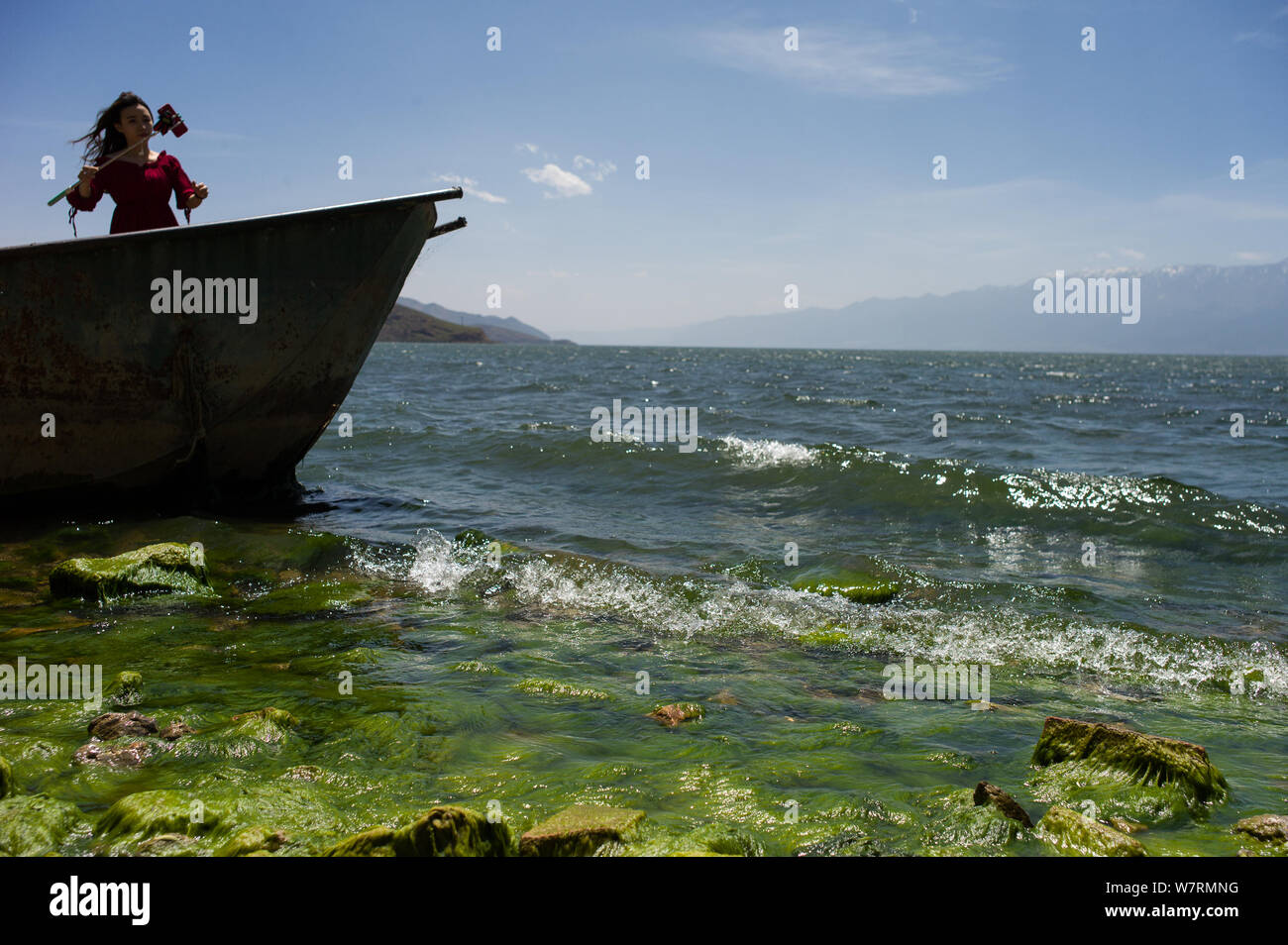 --FILE--A tourist takes a selfie by the polluted Erhai Lake in ...