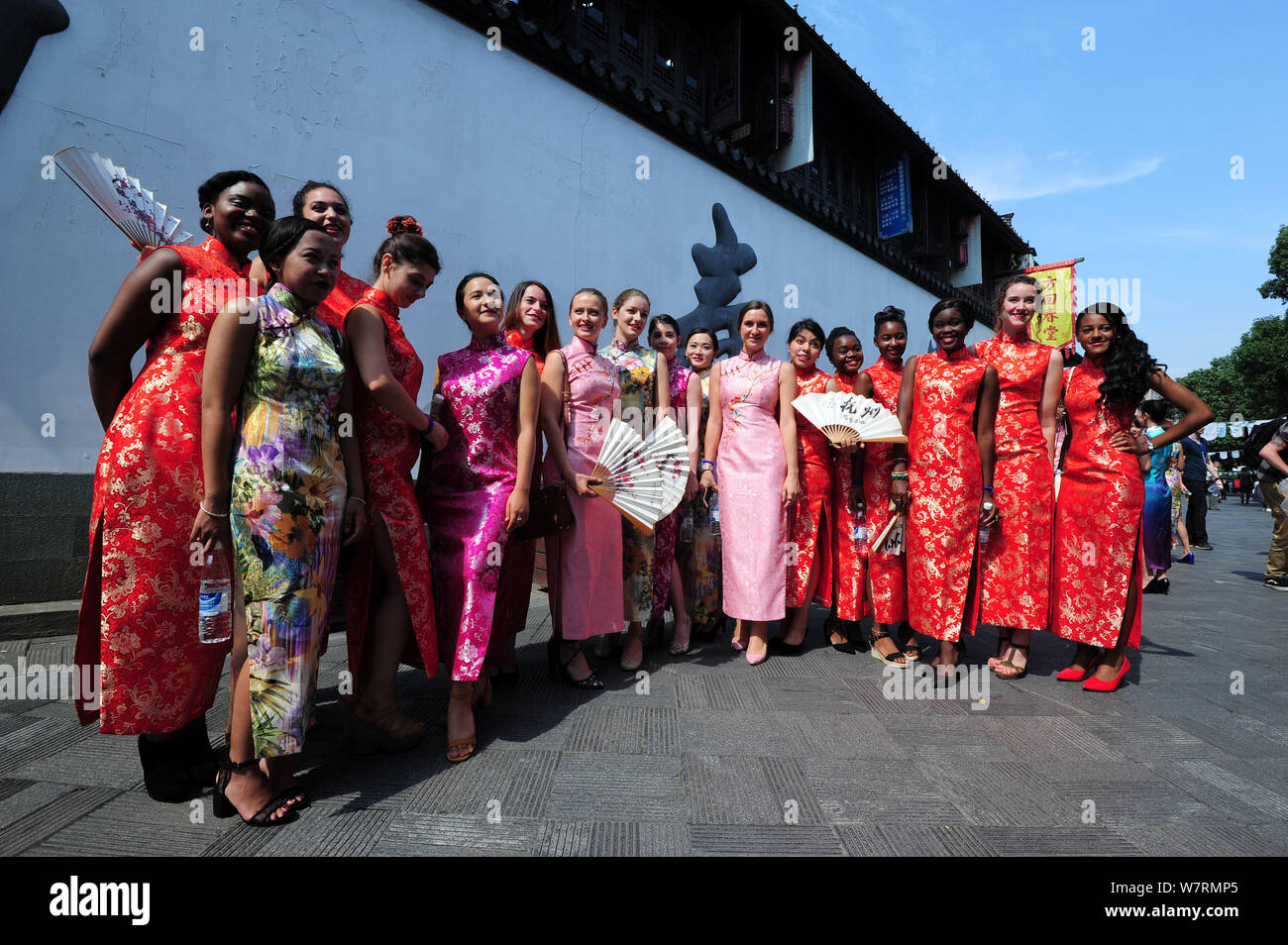 Women from different countries dressed in cheongsam, also known as ...