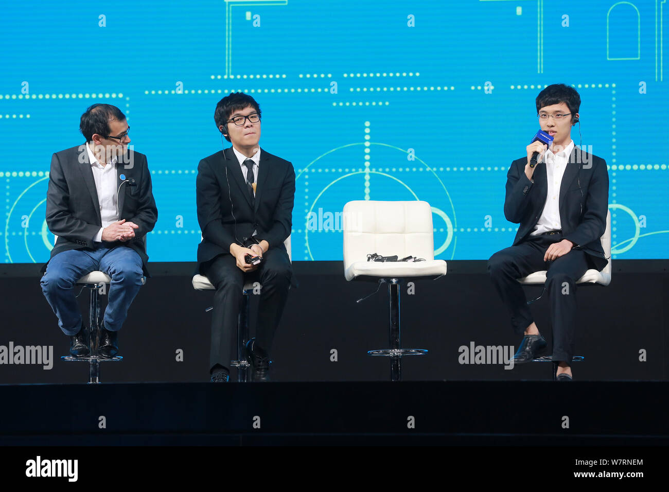 Chinese Go player Lian Xiao, right, speaks as Chinese Go players Ke Jie ...