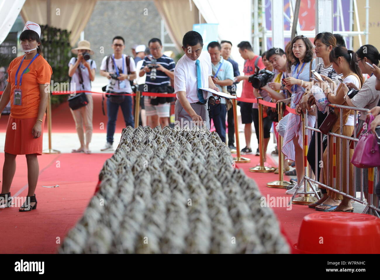 An official from the Guinness World Record counts zongzi, also known as ...