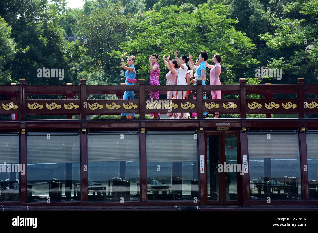 Women from different countries dressed in cheongsam, also known as ...