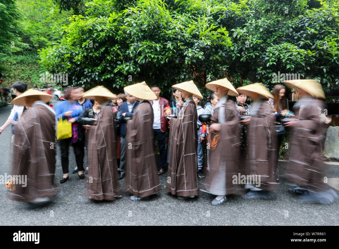 Chinese Buddhist monks holding alms bowls take part in a mendicants ...