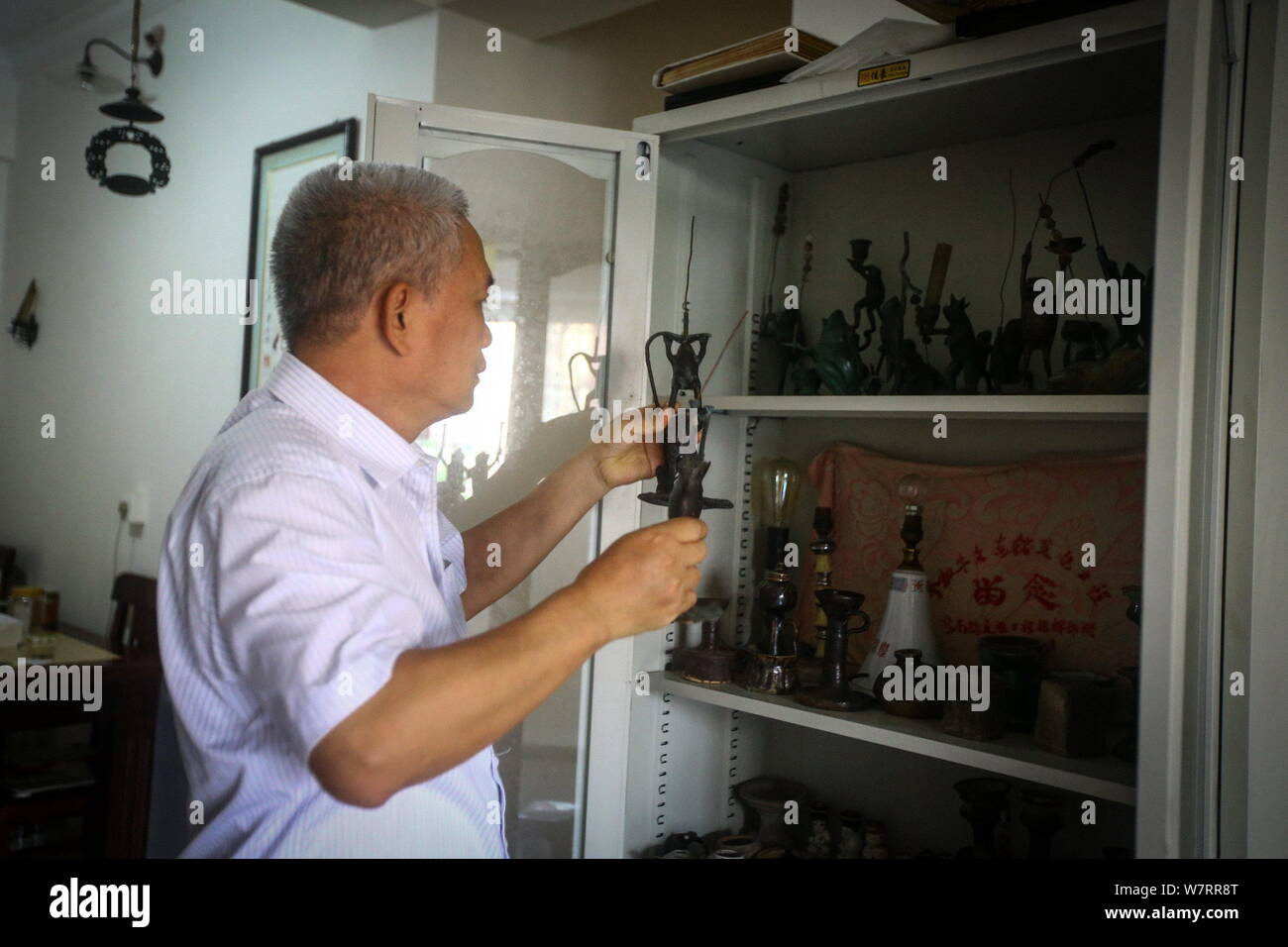 60-year-old Chinese lights and lamps collector Wang Fuhe shows his ...