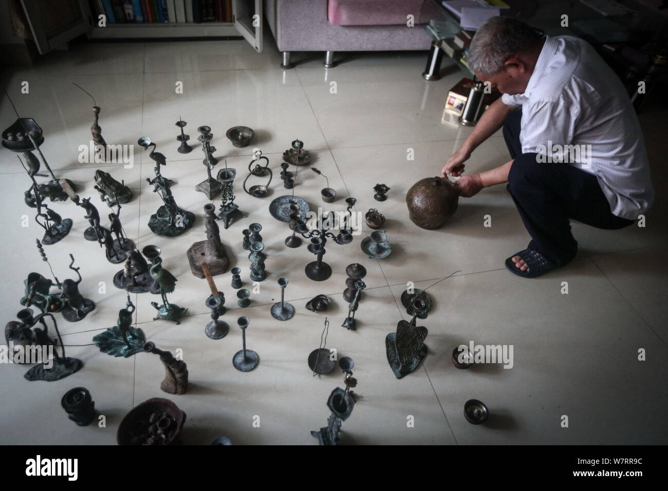 60-year-old Chinese lights and lamps collector Wang Fuhe shows his ...